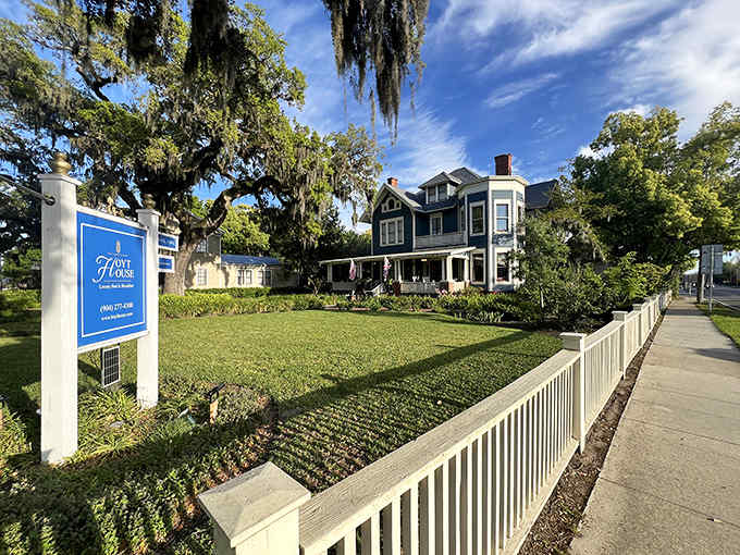 Victorian elegance meets Florida charm at this blue Queen Anne mansion, where history whispers from every corner of the meticulously maintained grounds.