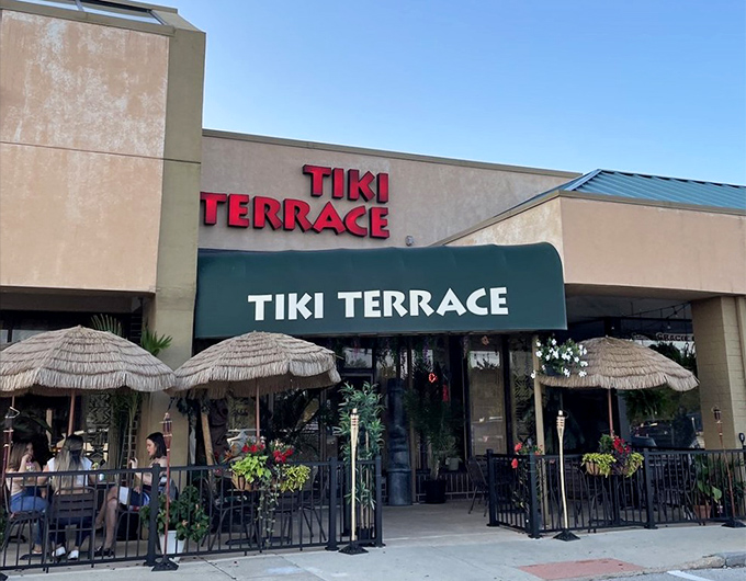 The entrance to Tiki Terrace beckons with its bamboo-lined bar and mysterious glow &ndash; like stepping into a secret tropical hideaway.