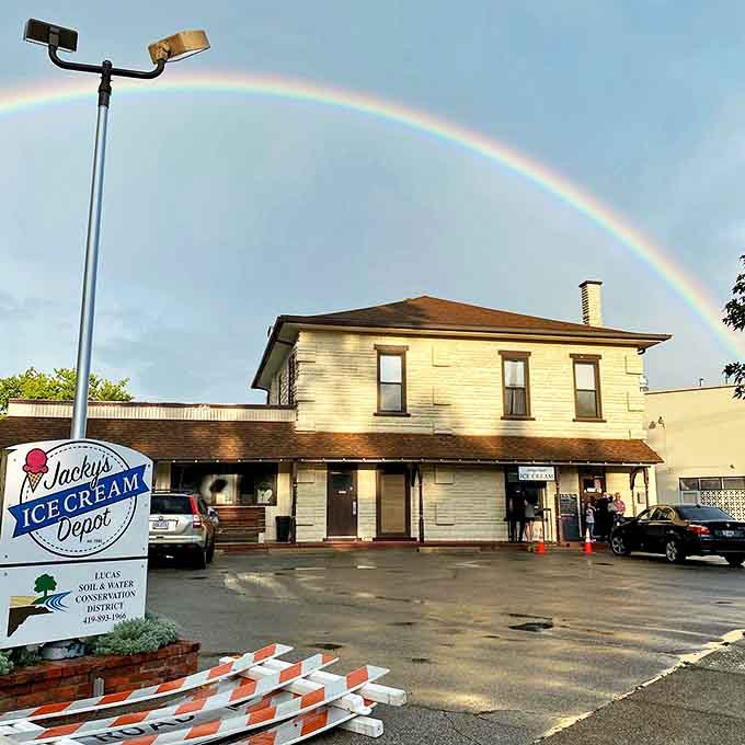 Jacky's Depot stands proudly beneath a perfect rainbow, as if Mother Nature herself is pointing the way to ice cream paradise.