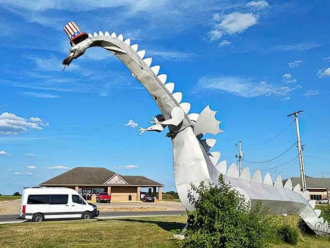 The magnificent Kaskaskia Dragon stands tall against the Illinois sky, its metallic body gleaming in the sunlight while sporting a patriotic top hat.