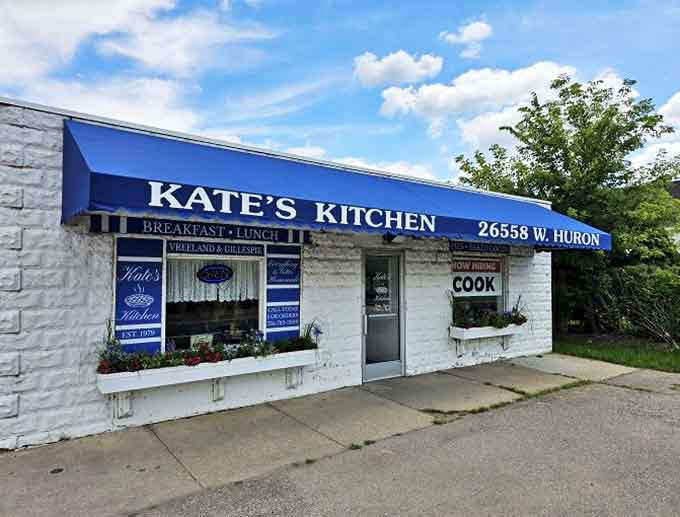 Kate's Kitchen exterior beckons with its unpretentious charm &ndash; a white building with blue awning promising homestyle delights within.