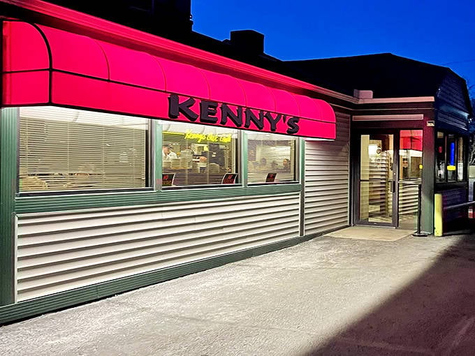 Kenny's iconic hot pink awning glows like a beacon in the night, promising comfort food and nostalgia under one unmistakable roof.