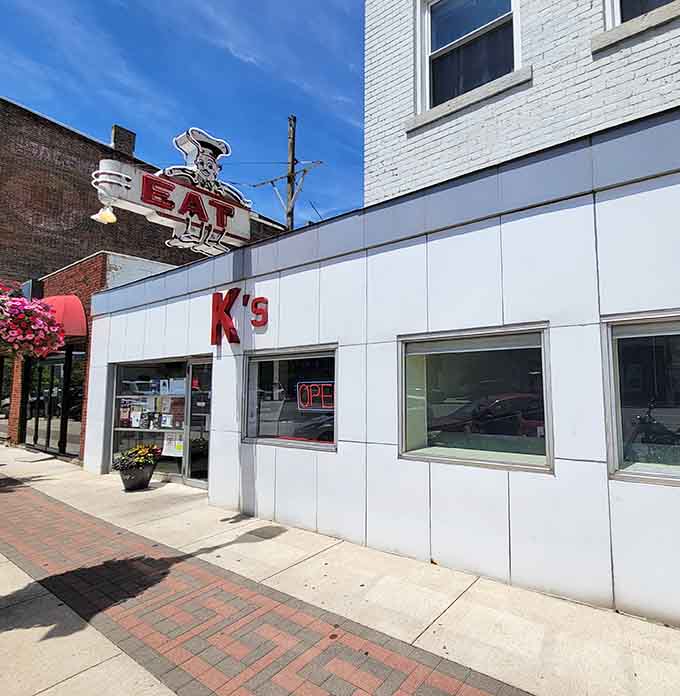 The unassuming white facade of K's Hamburger Shop, where that vintage "EAT" sign has been luring hungry travelers since Eisenhower was in office.