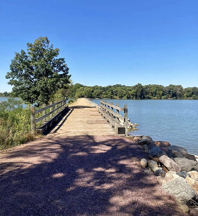 Lake Shetek State Park (Currie, MN): A wooden bridge stretches across calm waters, inviting adventurers to cross between worlds of forest and lake.