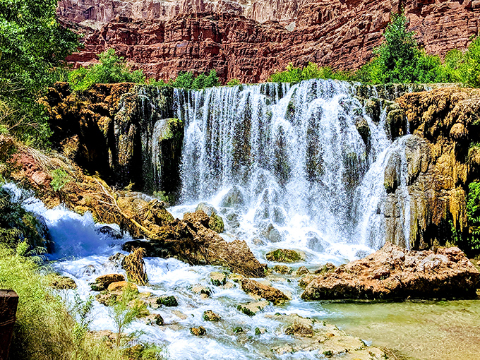 Nature's masterpiece: Navajo Falls cascades over red rock terraces, creating a turquoise oasis that seems almost too vibrant to be real.