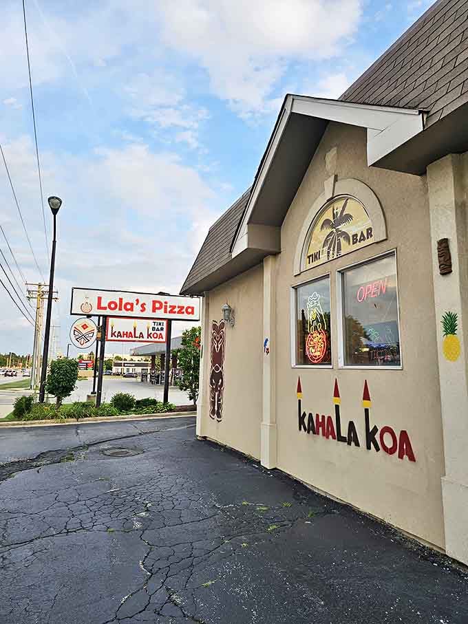 Lola's Pizza & Tiki Bar stands proudly on Rand Road, its unassuming exterior hiding the tropical paradise within. The tiki signage offers just a hint of the Hawaiian adventure awaiting hungry visitors.