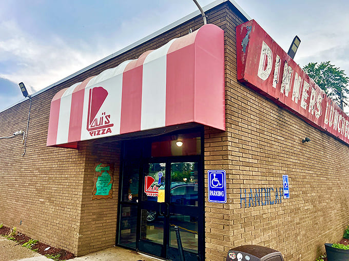 The iconic red and white striped awning of Loui's Pizza beckons hungry visitors like a delicious mirage in Hazel Park.