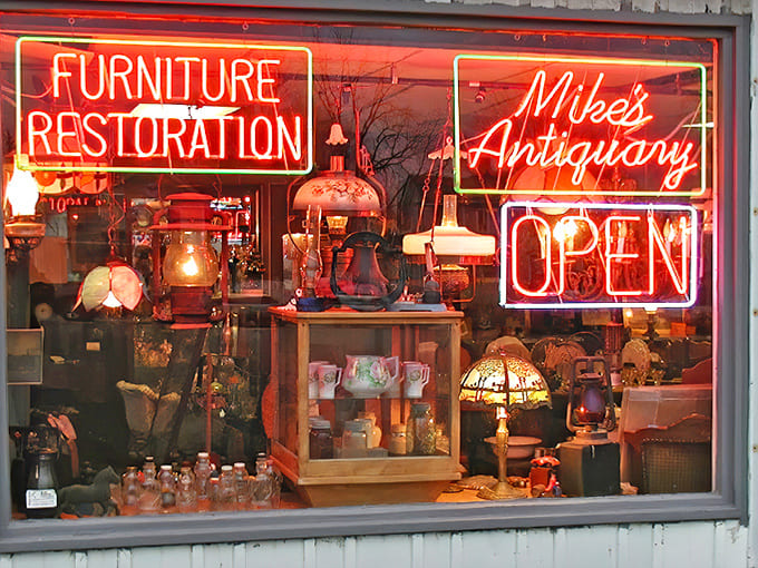 The glowing neon signs of Mike's Antiquary transform an ordinary storefront into a beacon for treasure hunters, promising vintage delights within.