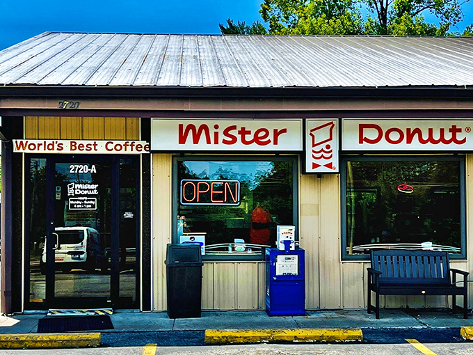 The unassuming storefront of Mister Donut in Godfrey, Illinois – where donut dreams come true behind a simple metal roof and vintage signage.