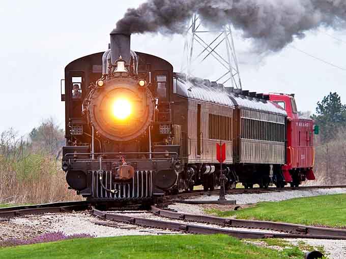 Steam meets soul as this magnificent locomotive charges down the track, its headlight piercing the misty Illinois morning like a beacon from the past.