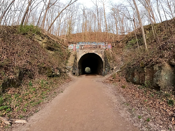 The entrance to Moonville Tunnel beckons through the trees, a brick-lined portal to history and mystery.