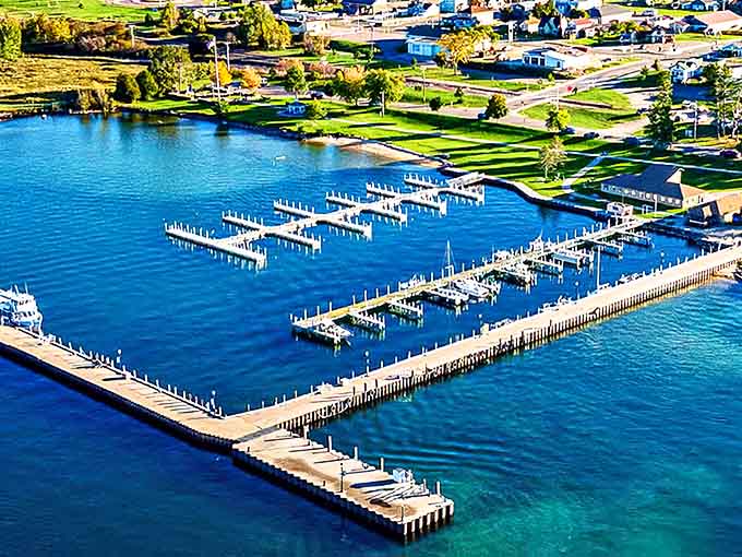 Munising's marina sparkles like a sapphire jewel, where boats bob gently against the backdrop of Michigan's most underrated waterfront paradise.