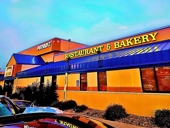 The vibrant orange and blue exterior of Nelson Bros. stands like a beacon for hungry travelers, promising oversized treats and Minnesota hospitality inside.