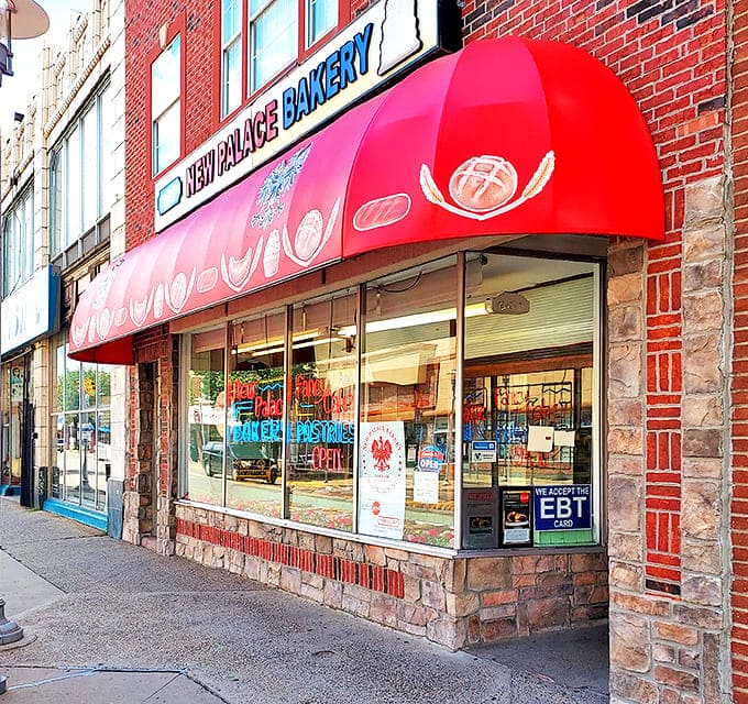 The iconic red awning of New Palace Bakery beckons sweet-toothed pilgrims to this Hamtramck institution like a sugary lighthouse.