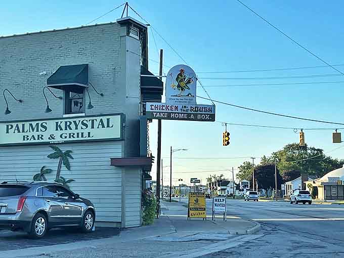The iconic white brick exterior of Palms Krystal Bar & Grill stands as a time capsule on Detroit's streetscape, complete with that can't-miss vintage chicken sign.