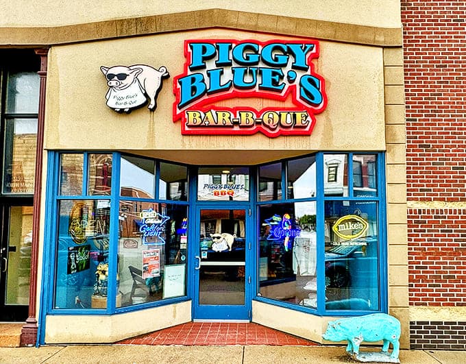 The vibrant blue storefront with its sunglasses-sporting pig mascot promises smoky delights within &ndash; Austin's beacon for barbecue lovers.
