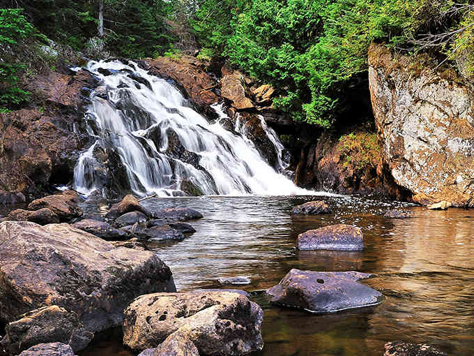 The magnificent cascade of Pinnacle Falls creates nature's perfect symphony, where rushing water meets ancient rock in a timeless dance of elements.