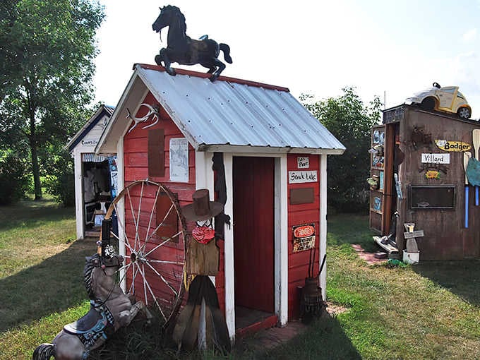 A whimsical red outhouse crowned with a black horse silhouette &ndash; Pottyville's architectural humor stands tall against the Minnesota sky.