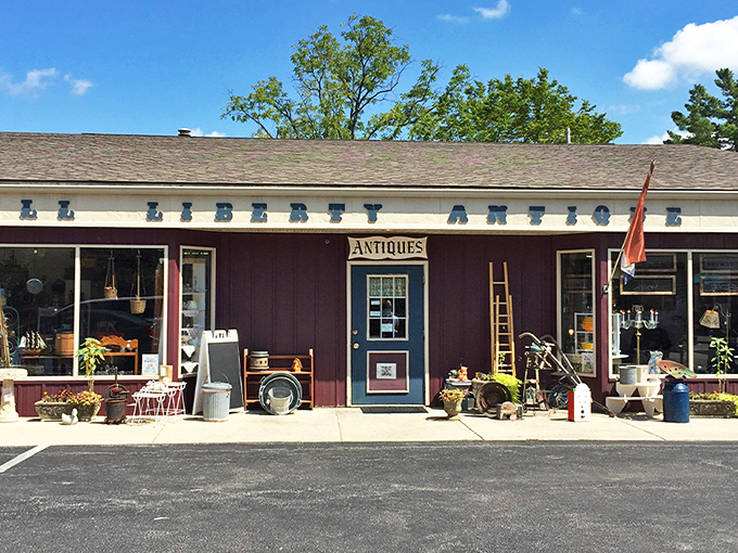 Powell Liberty Antique Mall: The burgundy facade with bold "ANTIQUES" lettering promises treasures within &ndash; like a time capsule disguised as a retail store.