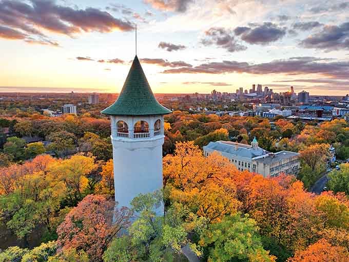 The Witch's Hat Water Tower stands majestically against a fiery sunset, its iconic silhouette watching over Minneapolis like a fairytale guardian.