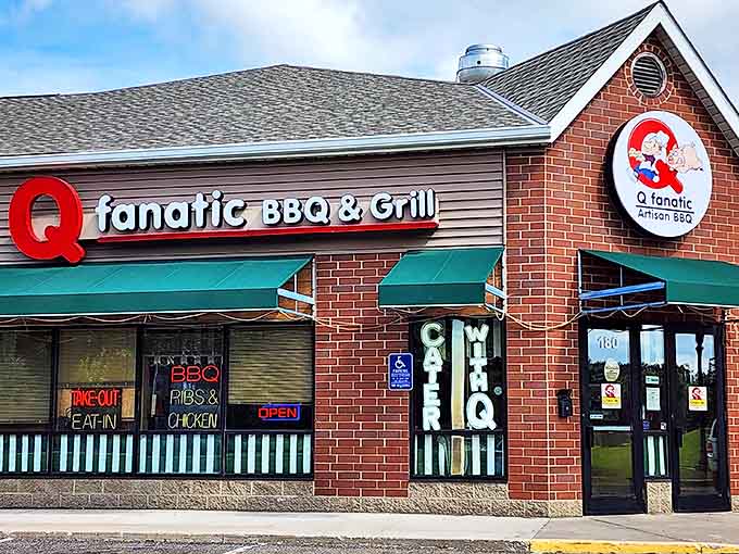 The brick facade of Q Fanatic stands proudly in Champlin, its cartoon pig logo promising smoky delights within these unassuming walls.