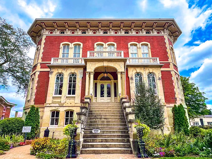 The Reddick Mansion's striking red brick facade stands proudly against the Illinois sky, a Victorian-era exclamation point in downtown Ottawa.
