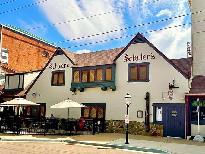 Schuler's charming Tudor-style exterior welcomes visitors with its cream walls and distinctive burgundy signage, a landmark on Marshall's Eagle Street since 1909.