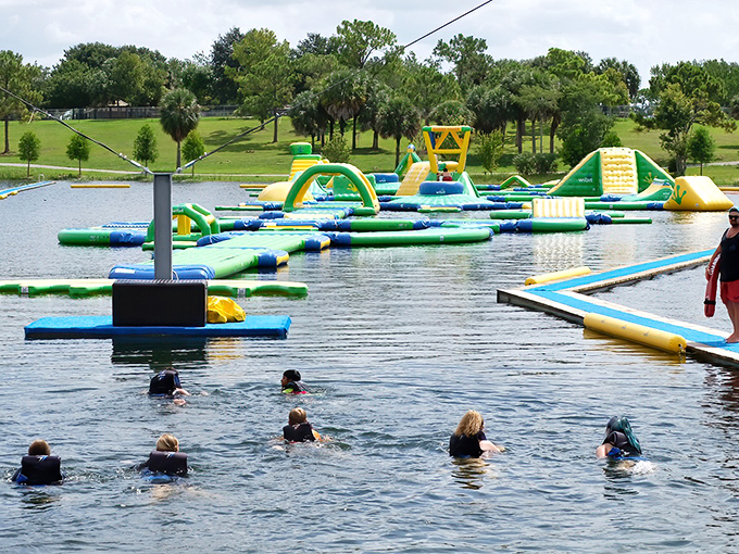 Aquatic playground heaven: Shark Wake Park's floating obstacle course transforms ordinary swimmers into gleeful obstacle warriors tackling colorful challenges.
