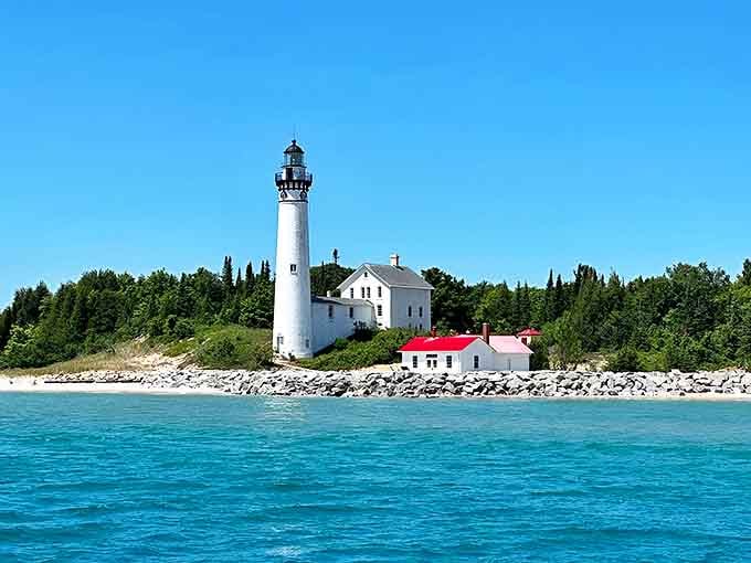 South Manitou Island's lighthouse stands sentinel against azure skies, a 104-foot maritime guardian that's witnessed more drama than a season of your favorite show.