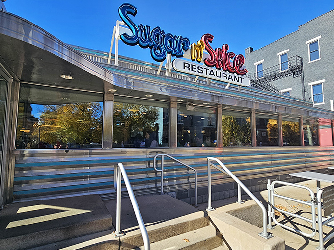 Sugar n' Spice Restaurant: The gleaming silver exterior with its vibrant neon signage stands like a retro time portal to breakfast paradise in Cincinnati's historic OTR neighborhood.