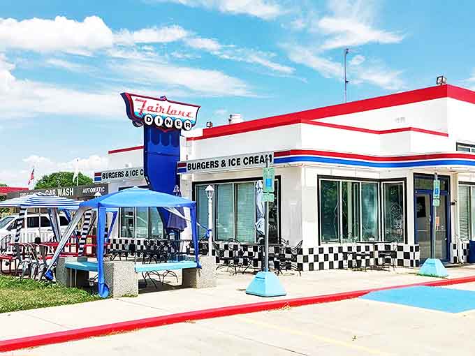 The iconic Fairlane Diner sign stands tall against the Illinois sky, a neon-lit promise of burgers, shakes, and a trip back in time.