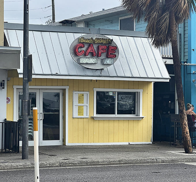 The sunny yellow exterior of Beach Shanty Cafe stands out like a beacon of breakfast hope on Clearwater Beach, promising morning delights within.