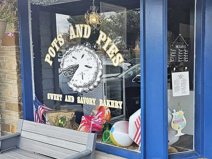 That hand-drawn smiling pie in the window knows exactly what's waiting for you inside, and it's not keeping any secrets about how good it's going to be.