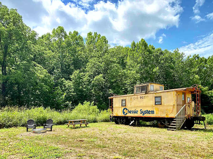The sunshine-yellow Chessie System caboose stands proudly against Ohio's lush landscape, a cheerful sentinel inviting weary travelers to an unconventional rest stop.