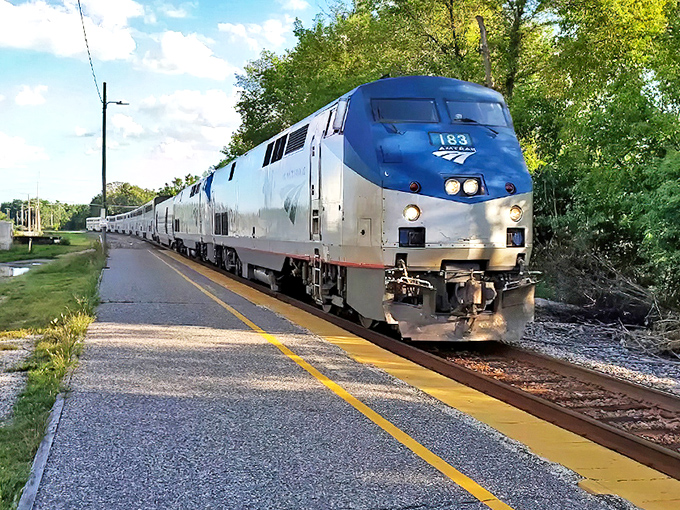 The sleek silver Amtrak Empire Builder arrives at a Wisconsin station, ready to whisk passengers through scenic landscapes year-round.