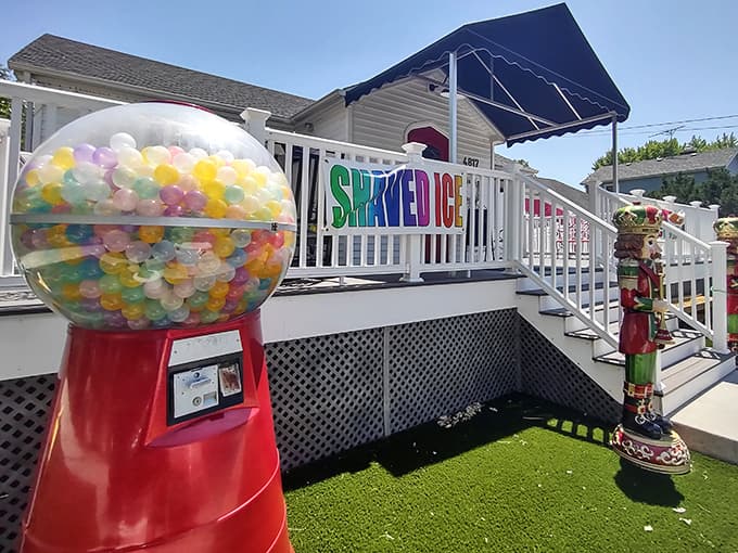 The enchanting exterior of SweetPeas beckons with its colorful "SHAVED ICE" sign and whimsical gumball machine, promising sweet adventures within.