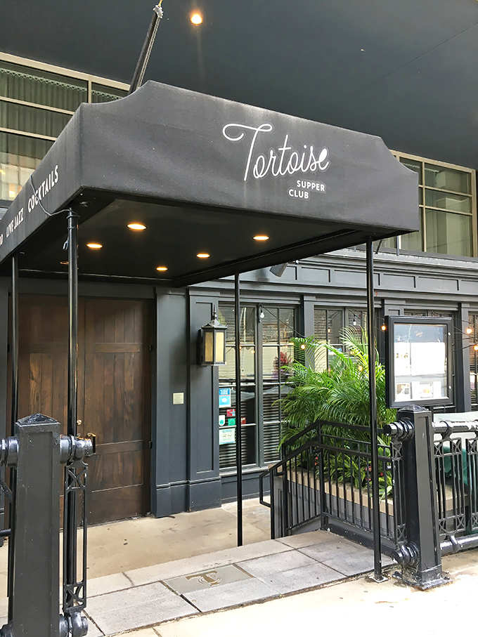 The elegant black awning of Tortoise Supper Club beckons passersby with promises of old-world glamour and modern culinary delights.