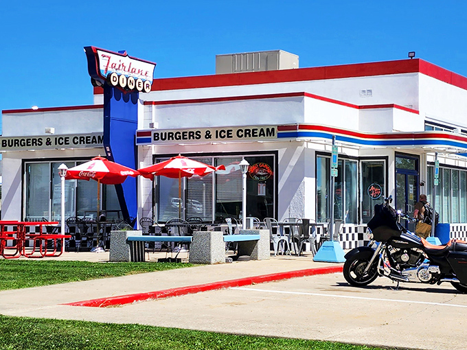 The Fairlane Diner's classic neon sign and red-white-blue facade stand like a beacon of nostalgia, promising burgers and ice cream that deliver on every childhood dream.