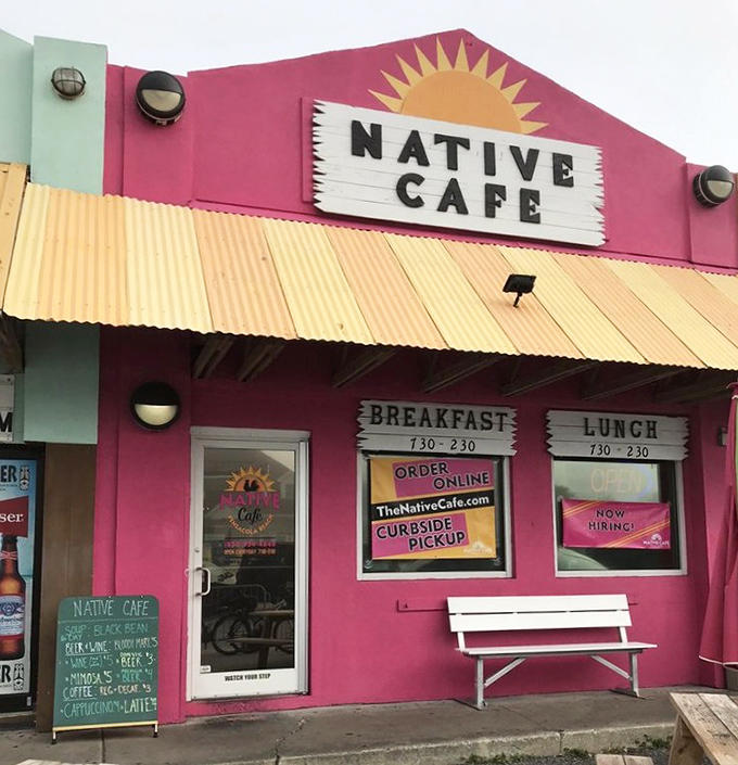 The vibrant pink exterior of Native Cafe beckons hungry beachgoers with its cheerful sun logo and promise of Florida flavor perfection.