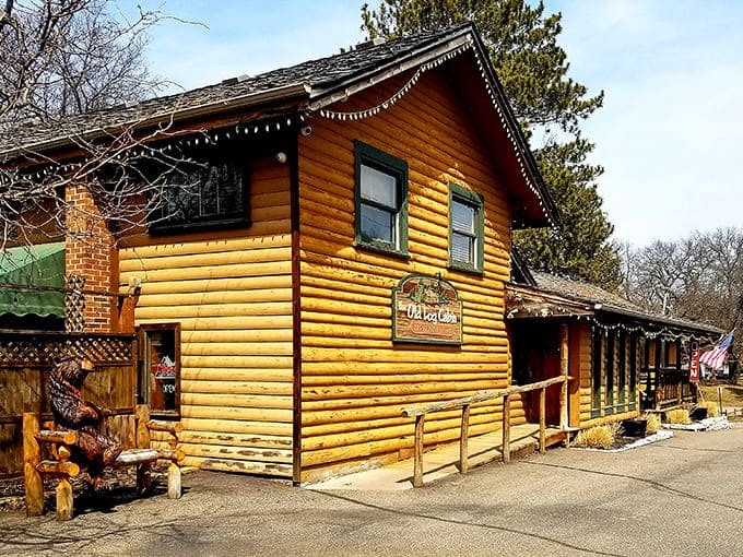 The golden-hued log cabin exterior beckons with rustic charm and twinkling lights, promising comfort and culinary delights within.
