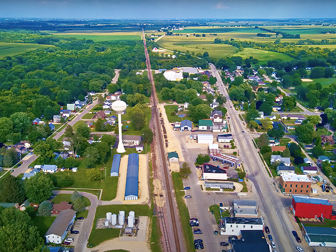 Kirkland from above: Where rolling farmland meets small-town charm in a perfectly Midwestern tableau. The railroad tracks tell stories of connection and commerce.