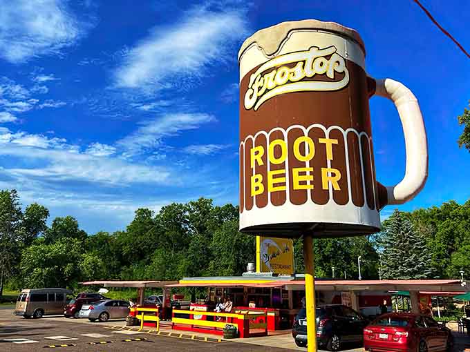 That towering root beer mug isn't just advertising, it's a promise of the frosty, creamy goodness waiting below at this beloved Minnesota landmark.