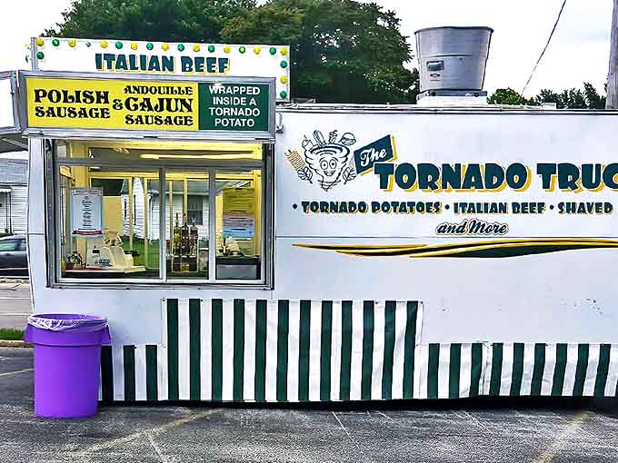 The Tornado Truck sits ready for action, its green and white stripes practically vibrating with carnival energy and fried food potential.