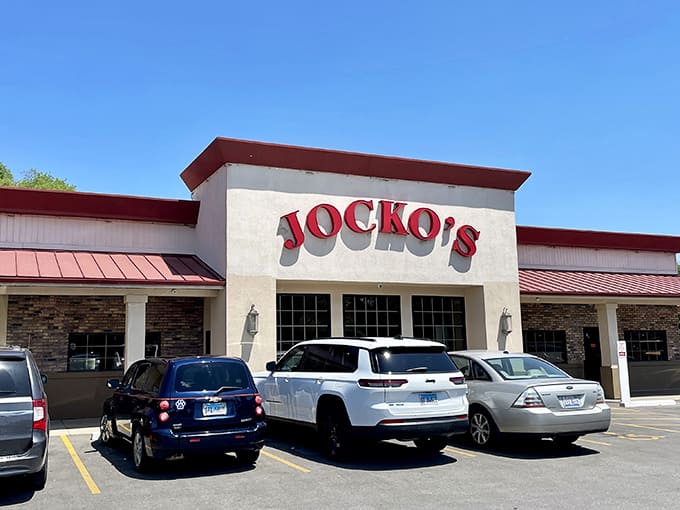 The red awning beckons like a beacon of deliciousness, promising pizza and nostalgia in equal measure inside.