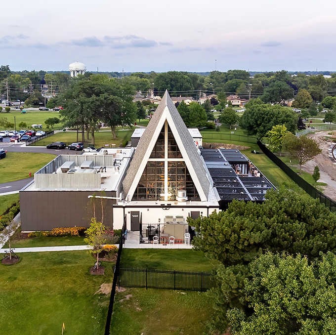 The striking A-frame architecture of The Foxtail On The Lake stands proudly against the Des Plaines sky, its former church identity creating an unforgettable first impression.