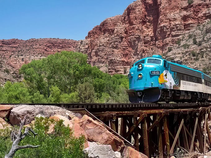 The iconic turquoise locomotive cuts through crimson canyon walls like a jewel-toned time machine, whisking passengers into Arizona's breathtaking wilderness.