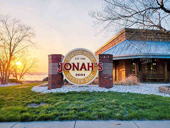 Jonah's Seafood House welcomes diners with its iconic sign glowing warmly against the sunset, promising maritime delights in landlocked Illinois.