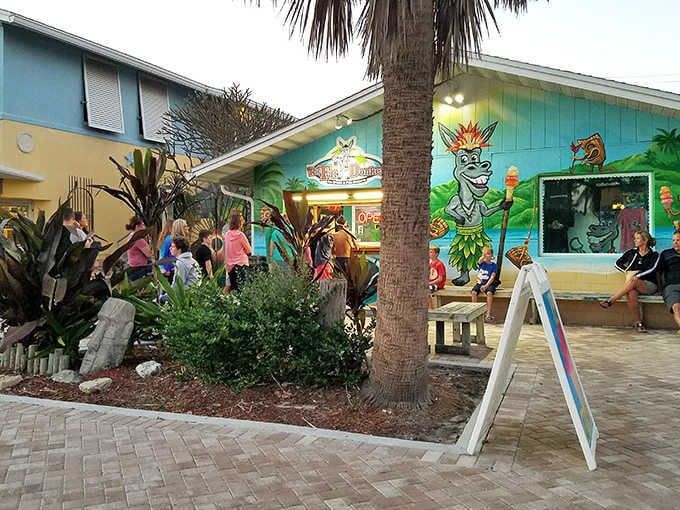 The turquoise oasis of The Fat Donkey beckons beach-goers with its tiki-roofed charm and whimsical donkey greeter, a tropical dessert paradise waiting to be discovered.