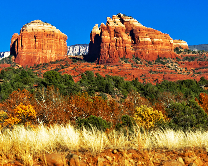 Cathedral Rock stands like nature's skyscraper, its rusty spires reaching skyward against Arizona's impossibly blue canvas &ndash; Sedona showing off again.