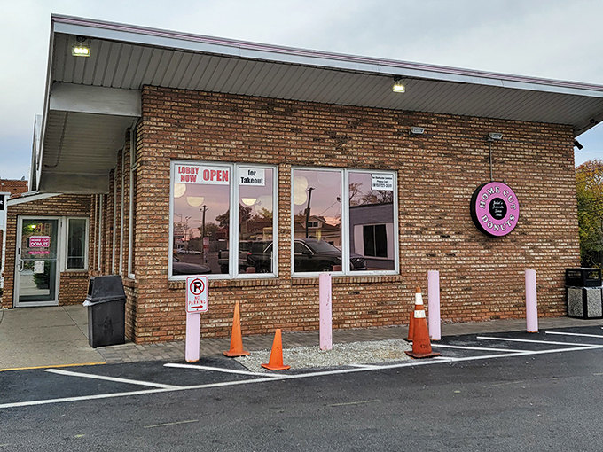 Exterior: The unassuming brick fa&ccedil;ade of Home Cut Donuts hides a wonderland of fried perfection, with those pink poles standing guard like sugary sentinels.